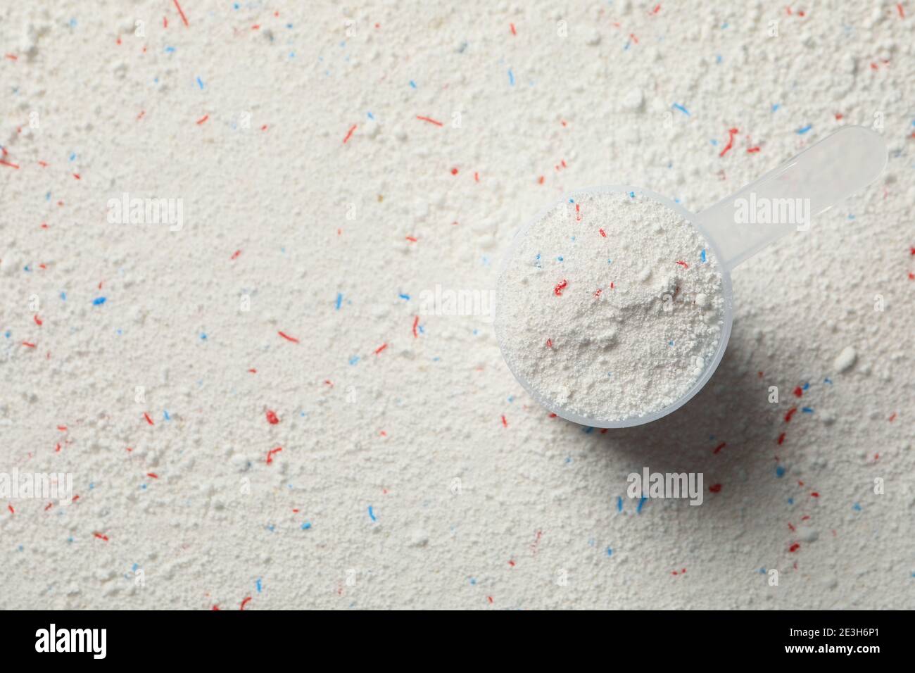 Scoop with washing powder on washing powder background Stock Photo - Alamy