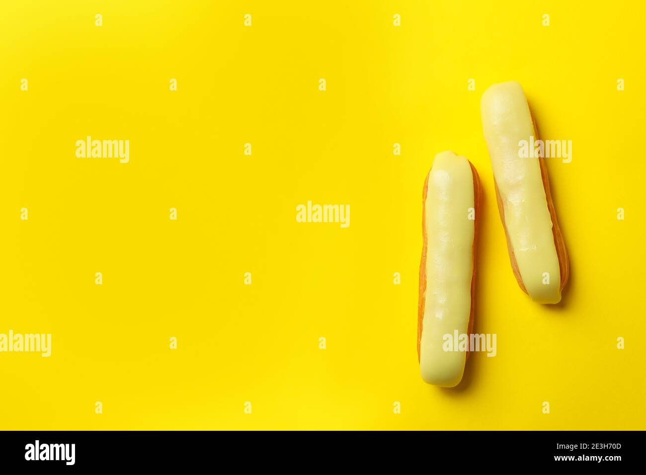 Delicious eclairs with custard on yellow background Stock Photo - Alamy
