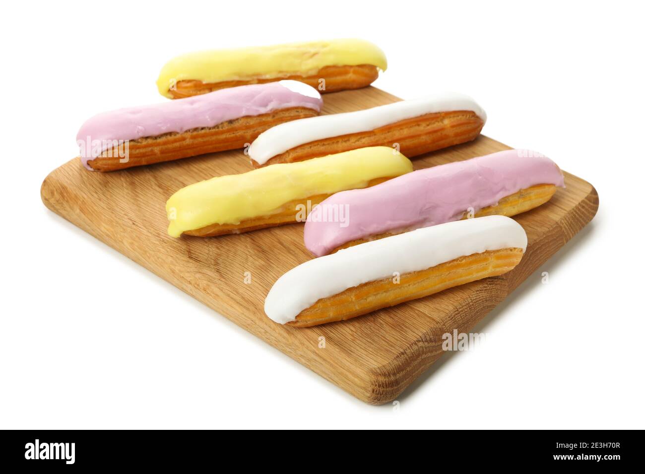 Board with eclairs with custard isolated on white background Stock ...