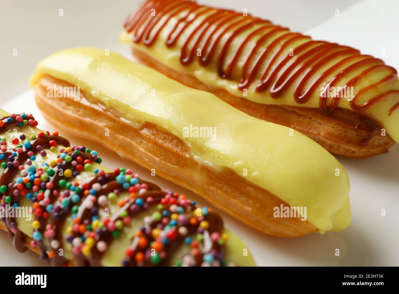 Tasty eclairs with custard and delicious topping, close up Stock Photo ...