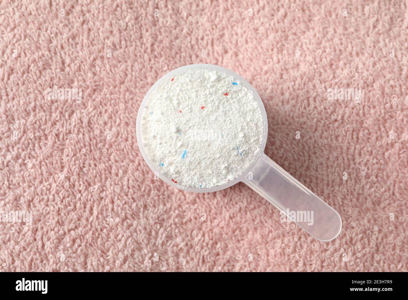 Scoop with washing powder on towel background Stock Photo - Alamy