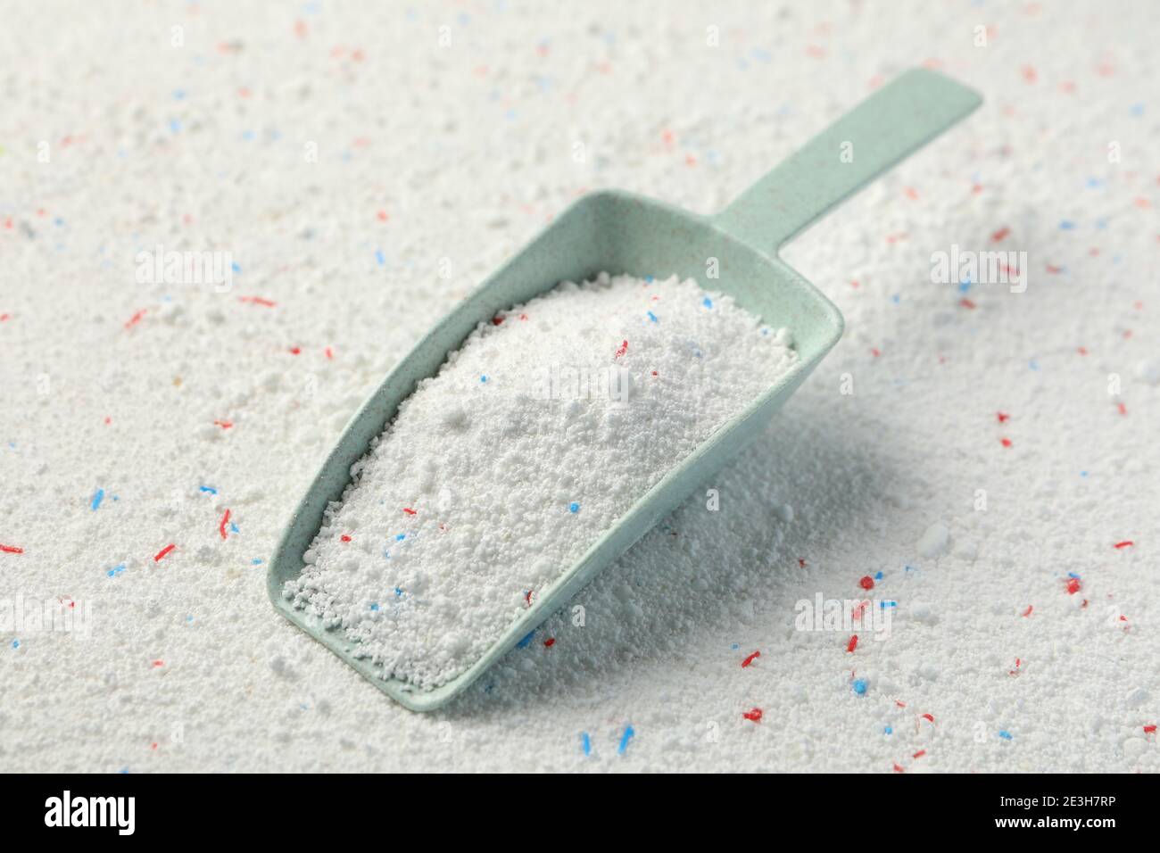 Scoop with washing powder on washing powder background Stock Photo - Alamy