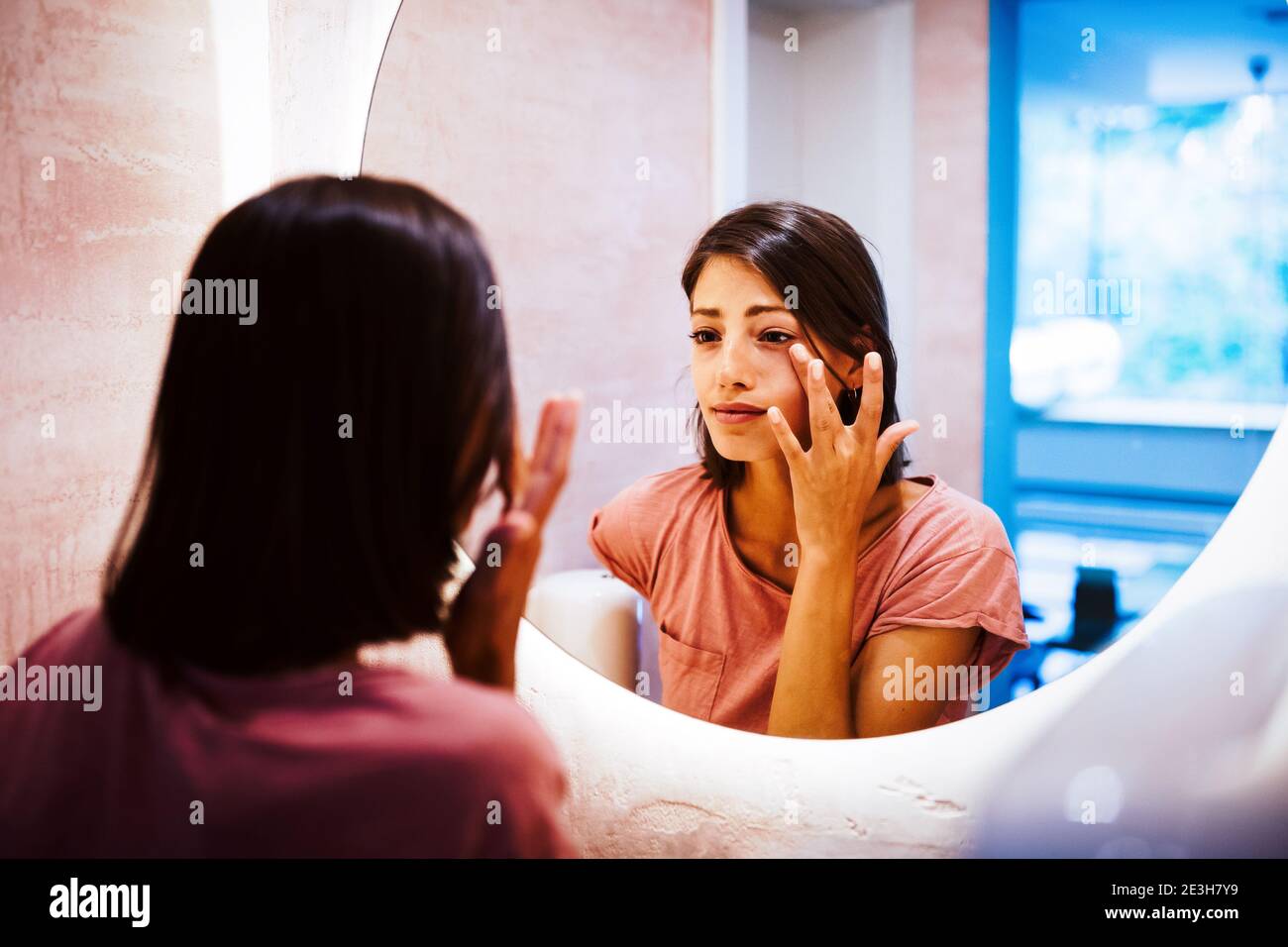 Mirror reflection of a woman worrying because of wrinkles on her ...