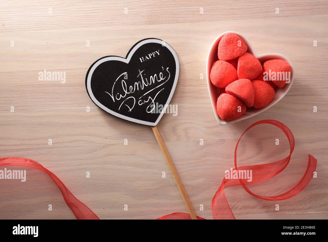 Heart shaped poster with happy valentines day message and jelly sweets ...