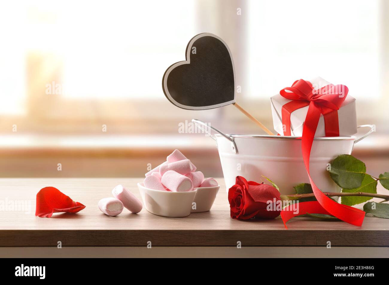 Romantic celebration with gift, rose, and container with jelly and ...