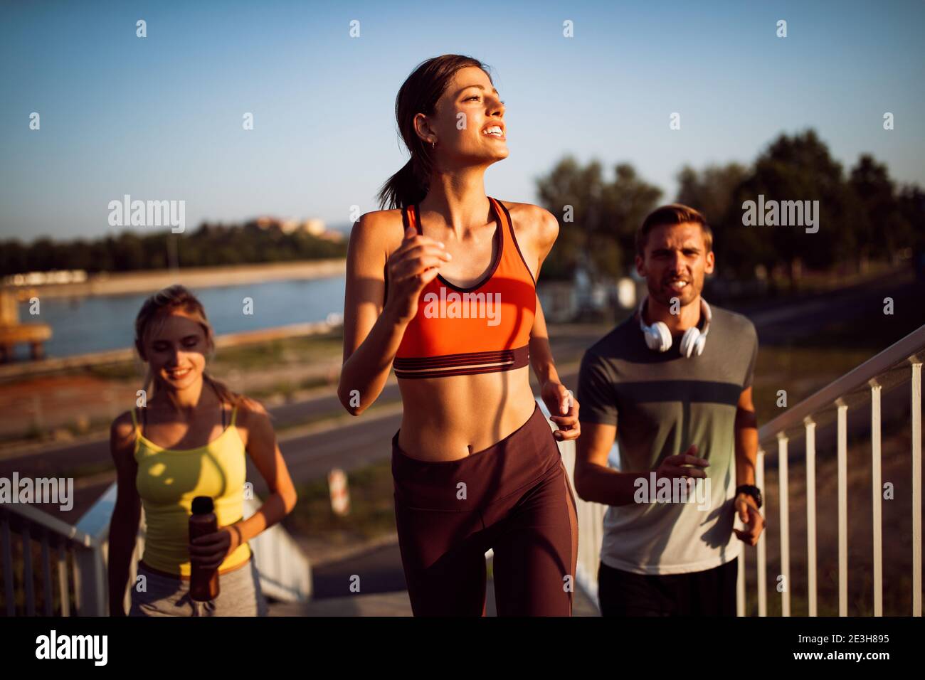 Fitness, sport, people and running concept. Happy fit friends running ...