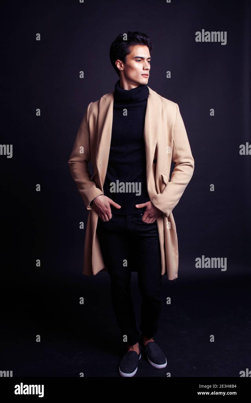 handsome asian fashion looking man posing in studio on black background ...