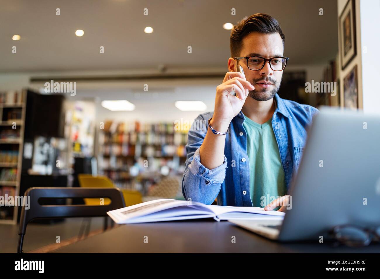 Student preparing exam and learning lessons in school library Stock ...