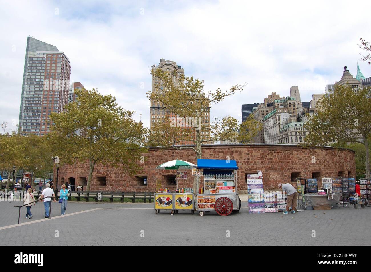 New York USA skyscrapers and food sellers with Castle Clinton in the ...