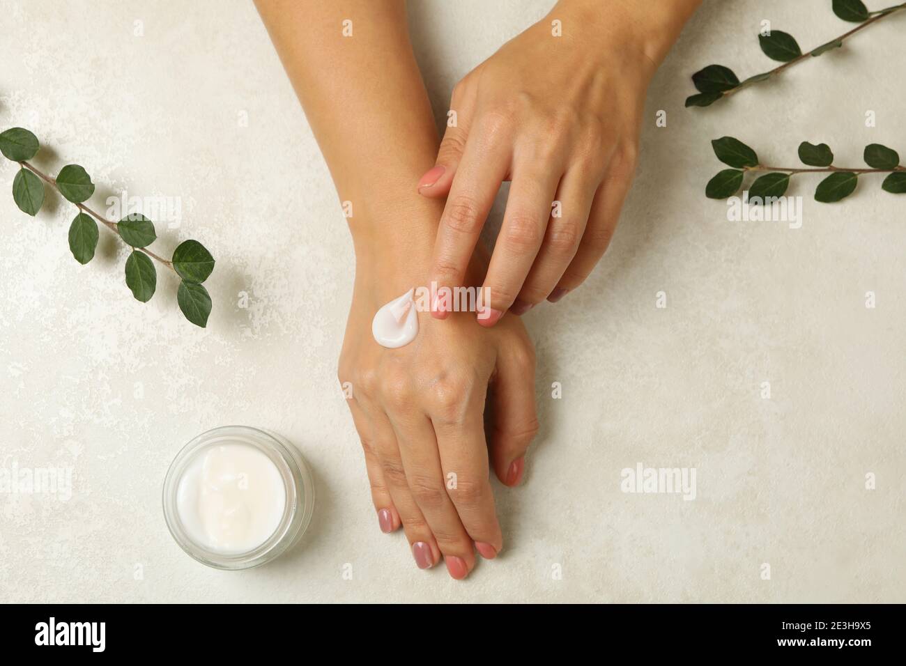 Female hands with cosmetics cream on white background Stock Photo - Alamy