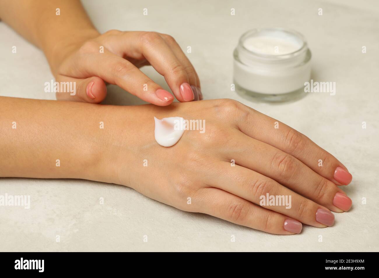 Female hands with cosmetics cream on white background Stock Photo - Alamy
