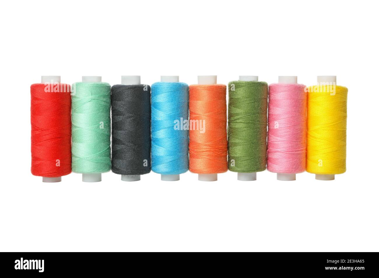 Color thread spools isolated on white background Stock Photo - Alamy