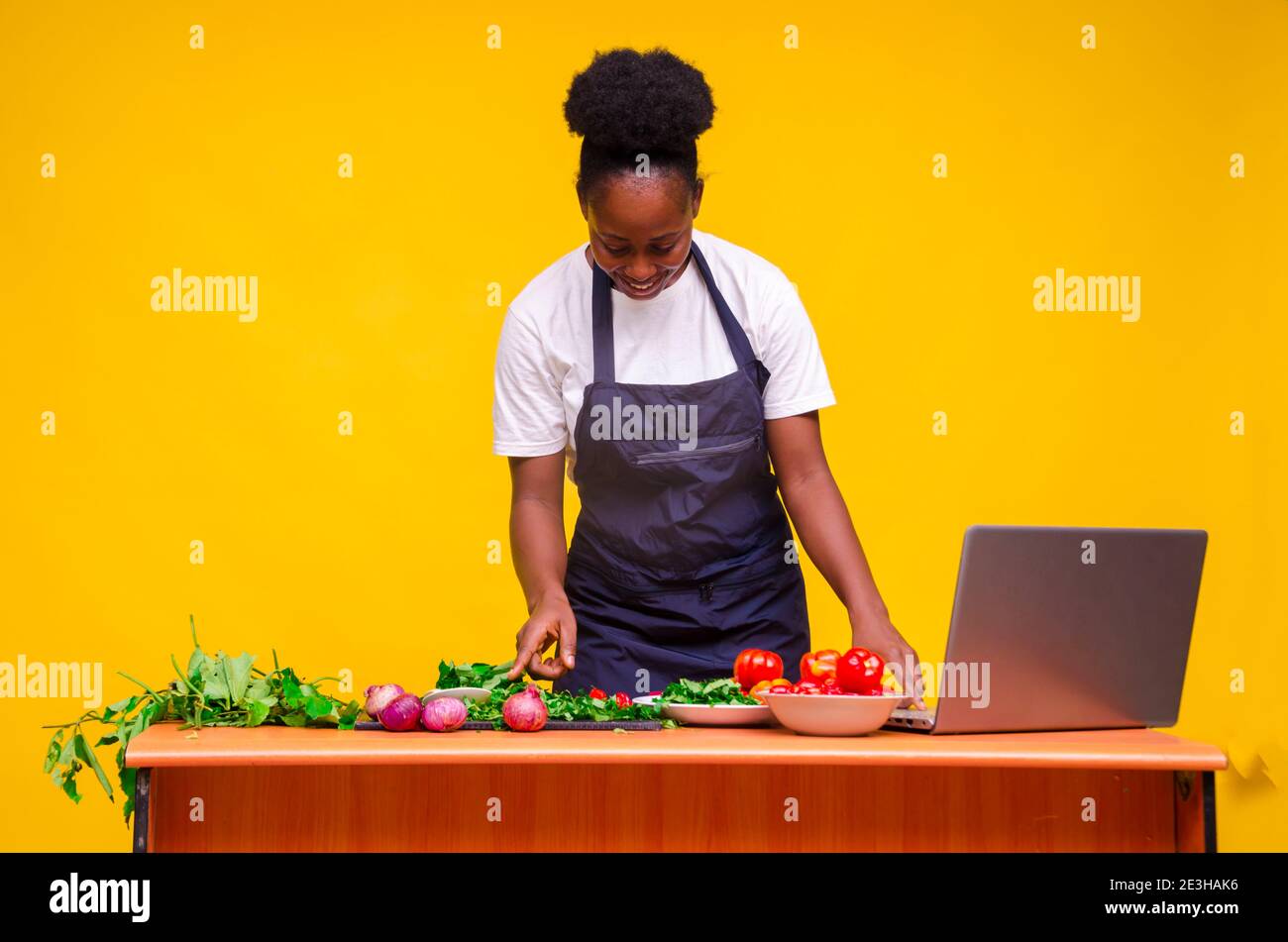 young beautiful african chef smiling isolated over yellow background ...