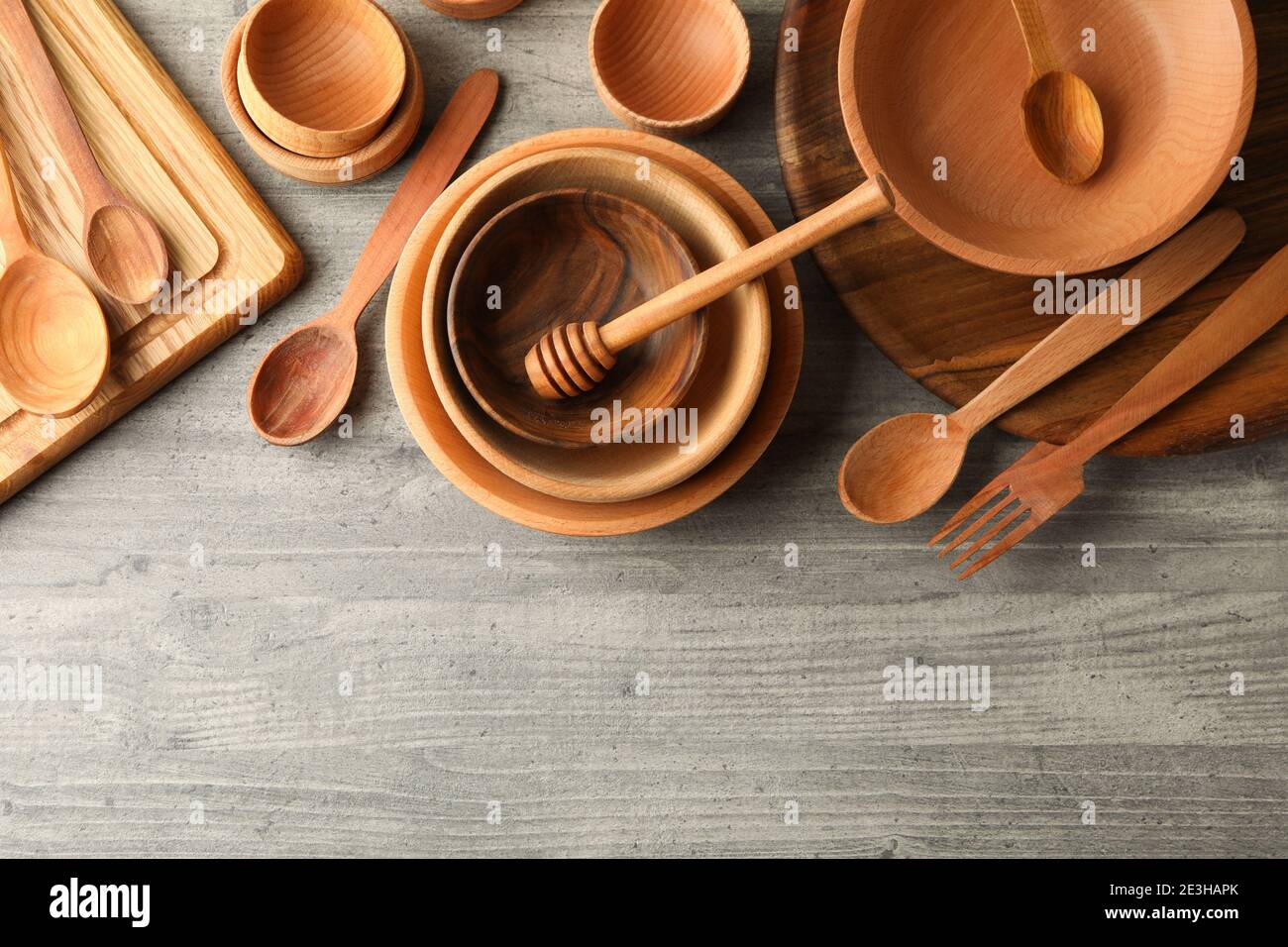 Different wooden dishes on gray table, top view Stock Photo - Alamy