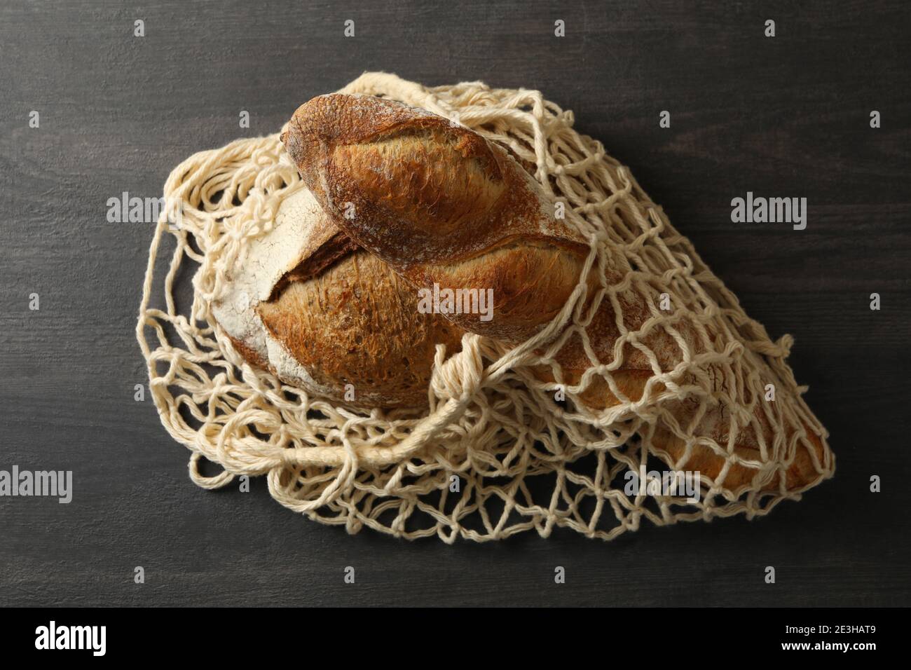 String bag with bread on black background Stock Photo - Alamy