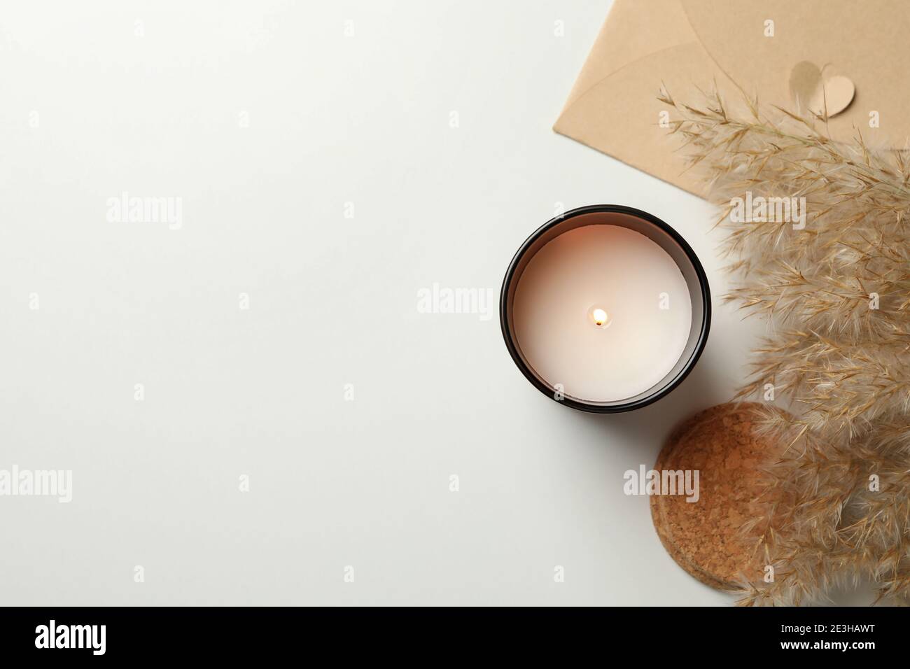 Scented candle, envelope and reed on white background Stock Photo - Alamy