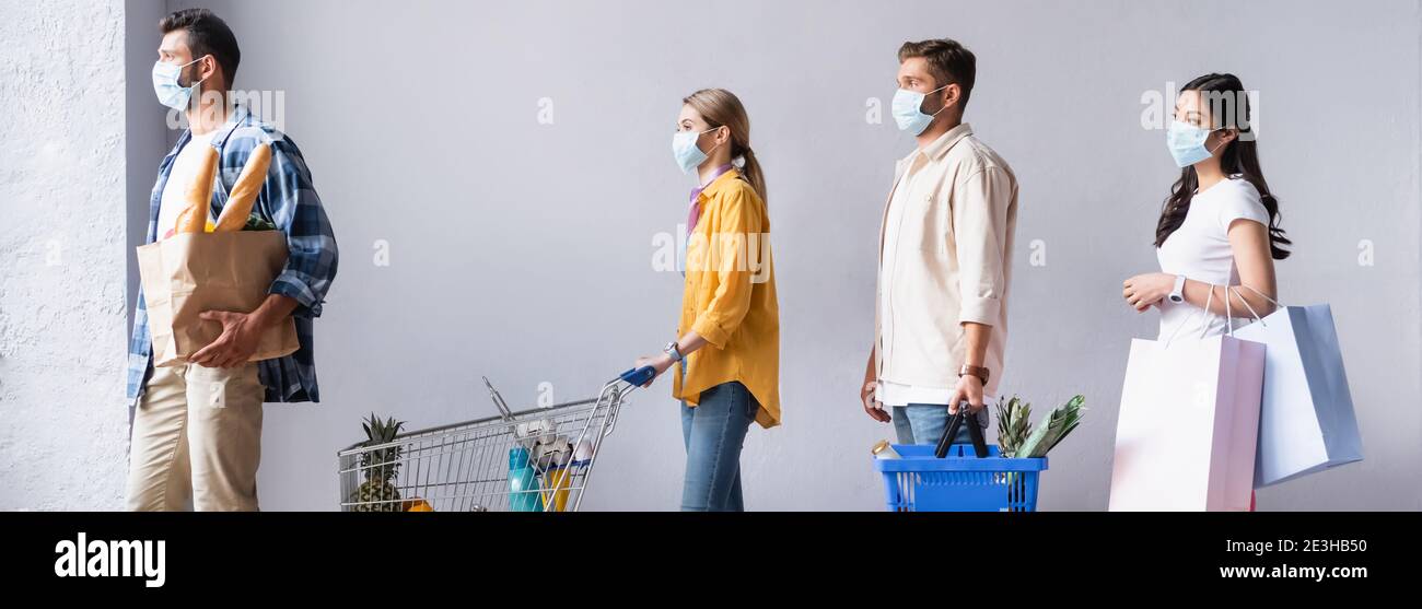 Multicultural people in medical masks holding shopping bags and ...