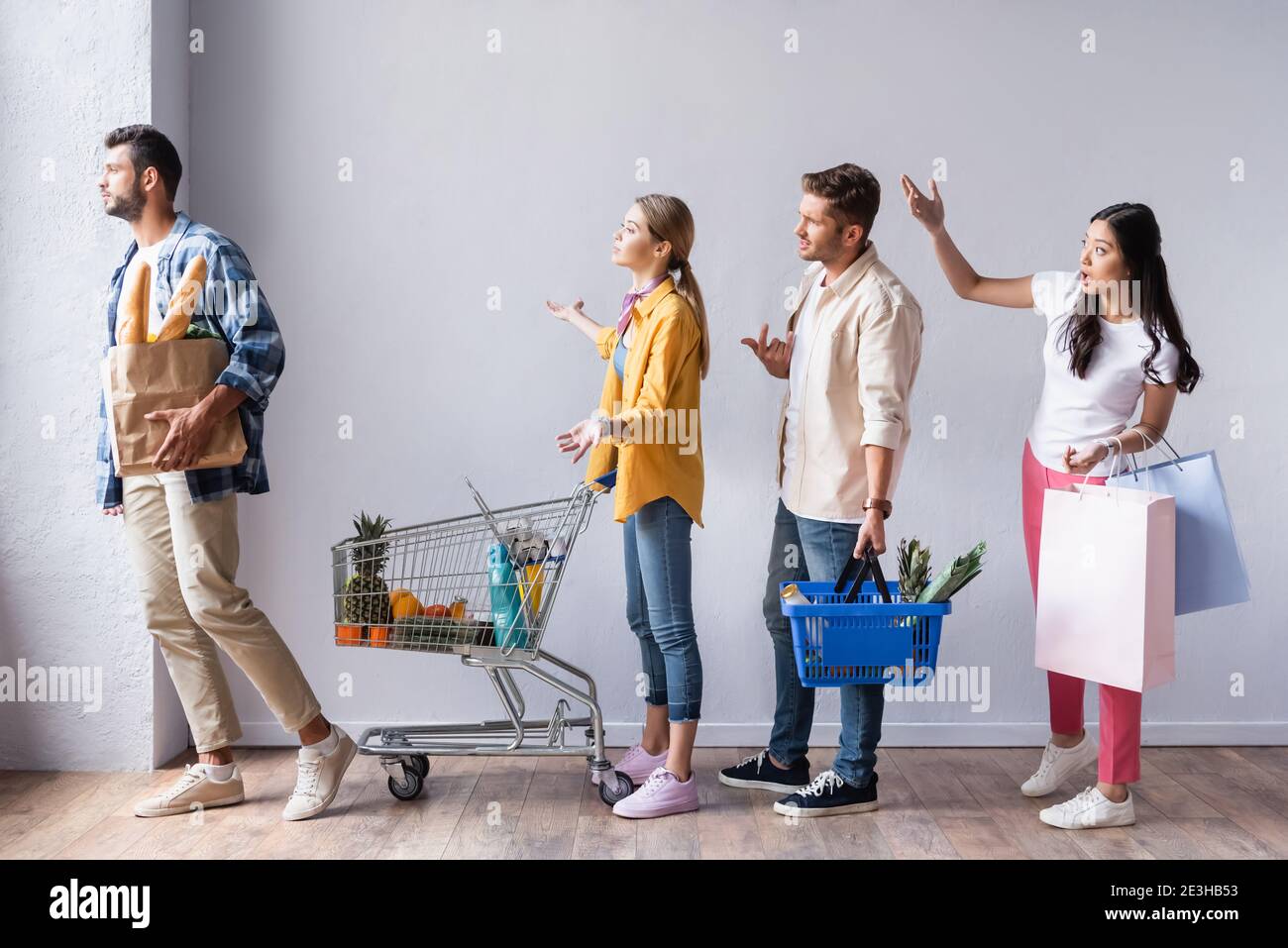 Angry multicultural customers with purchases pointing with hands in ...