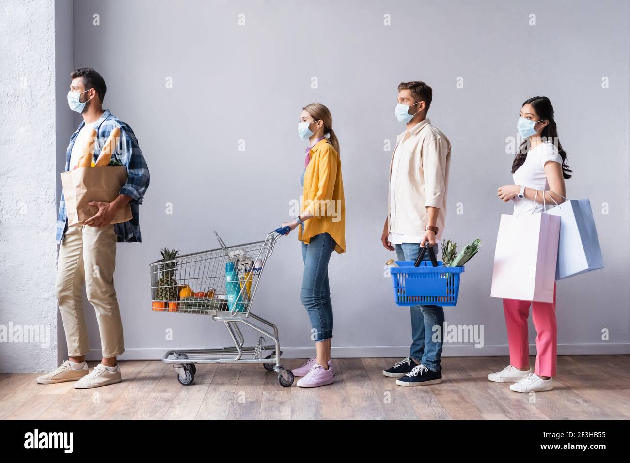 Multicultural people in medical masks holding shopping cart, basket ...