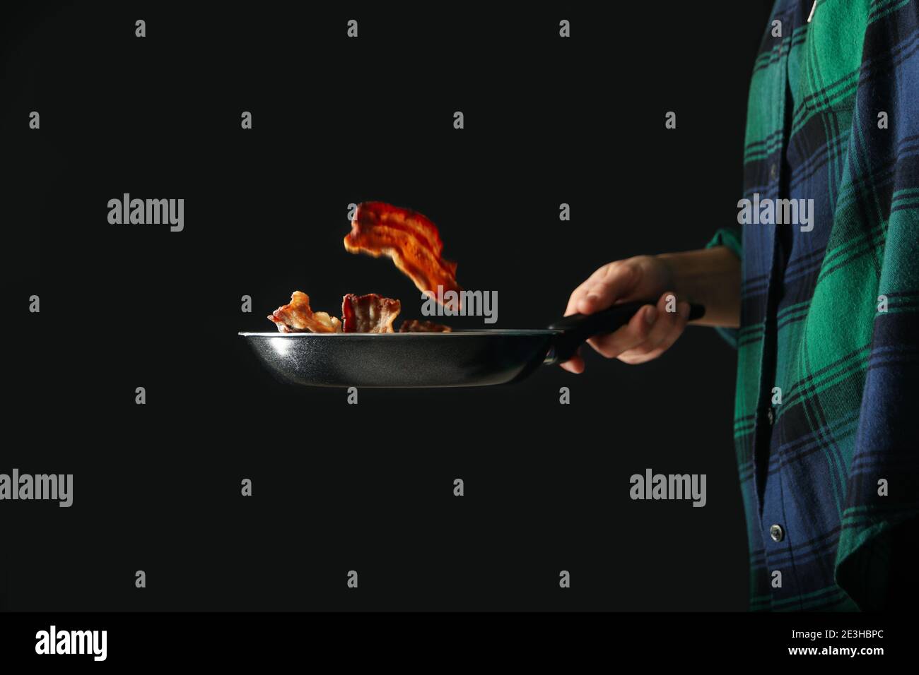 Woman frying bacon hi-res stock photography and images - Alamy