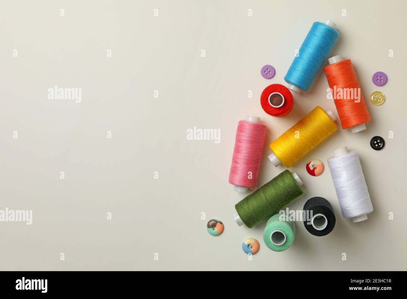 Sewing threads and buttons on white background, space for text Stock ...