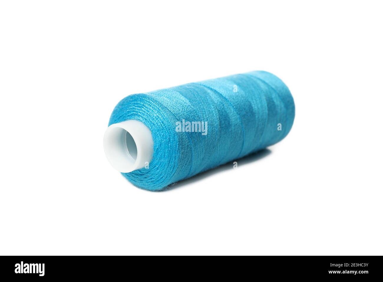 Blue spool of thread isolated on white background Stock Photo - Alamy