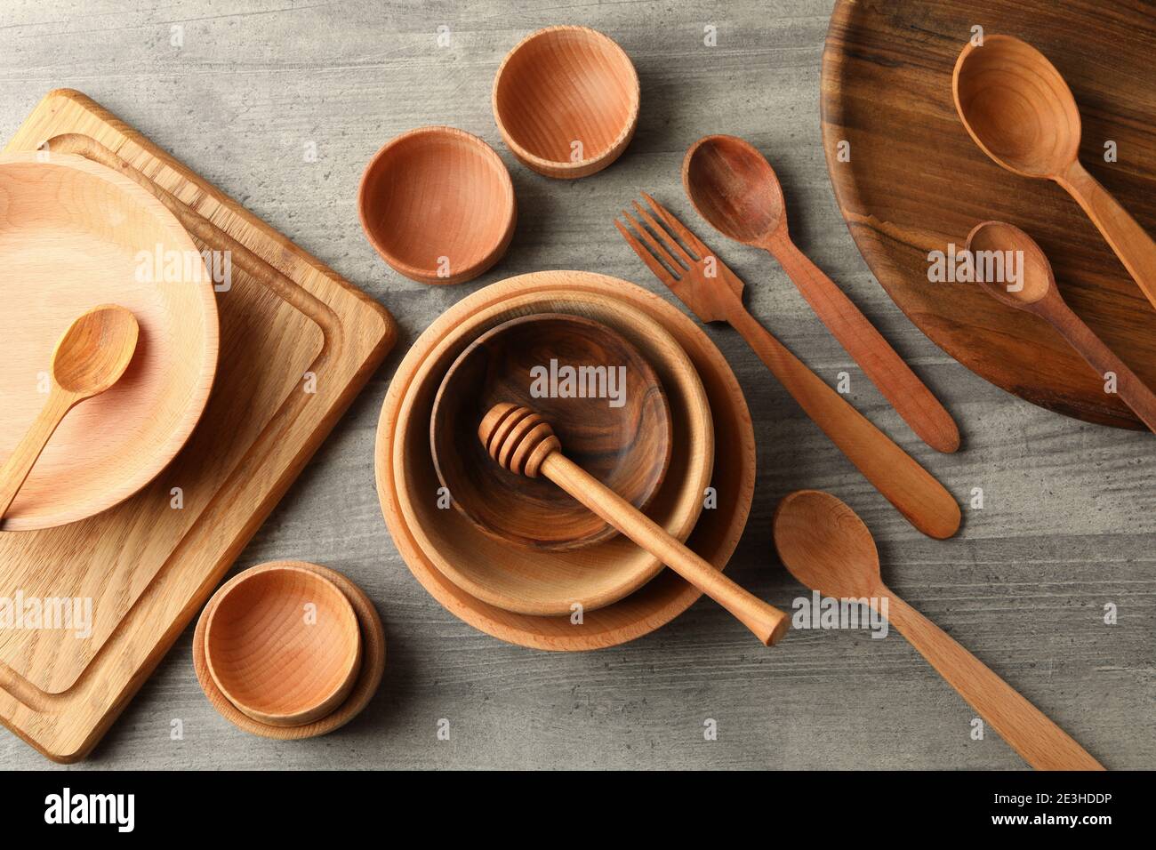 Different wooden dishes on gray table, top view Stock Photo - Alamy