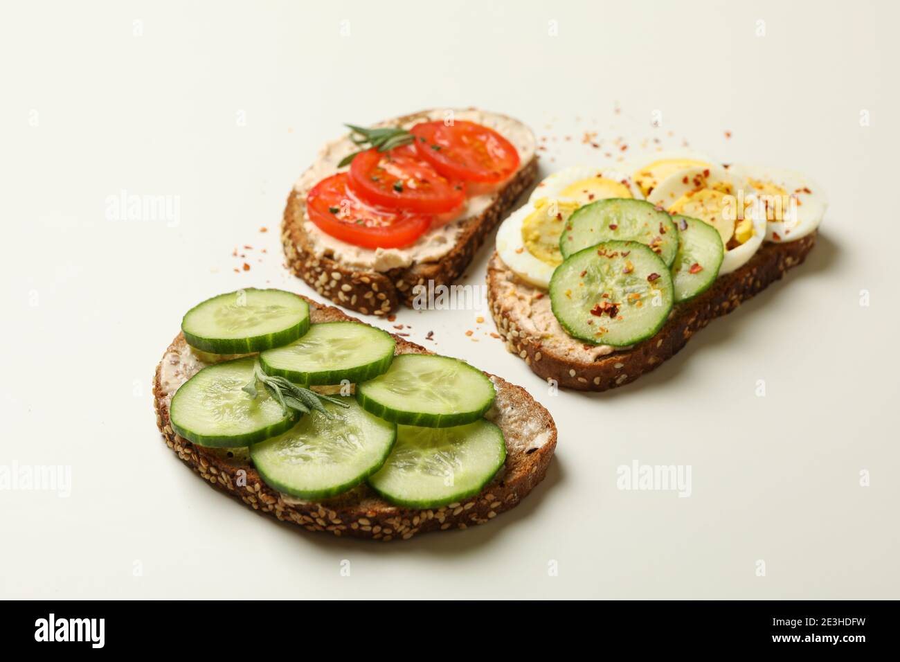 Tasty toasts with different topping on white background Stock Photo - Alamy