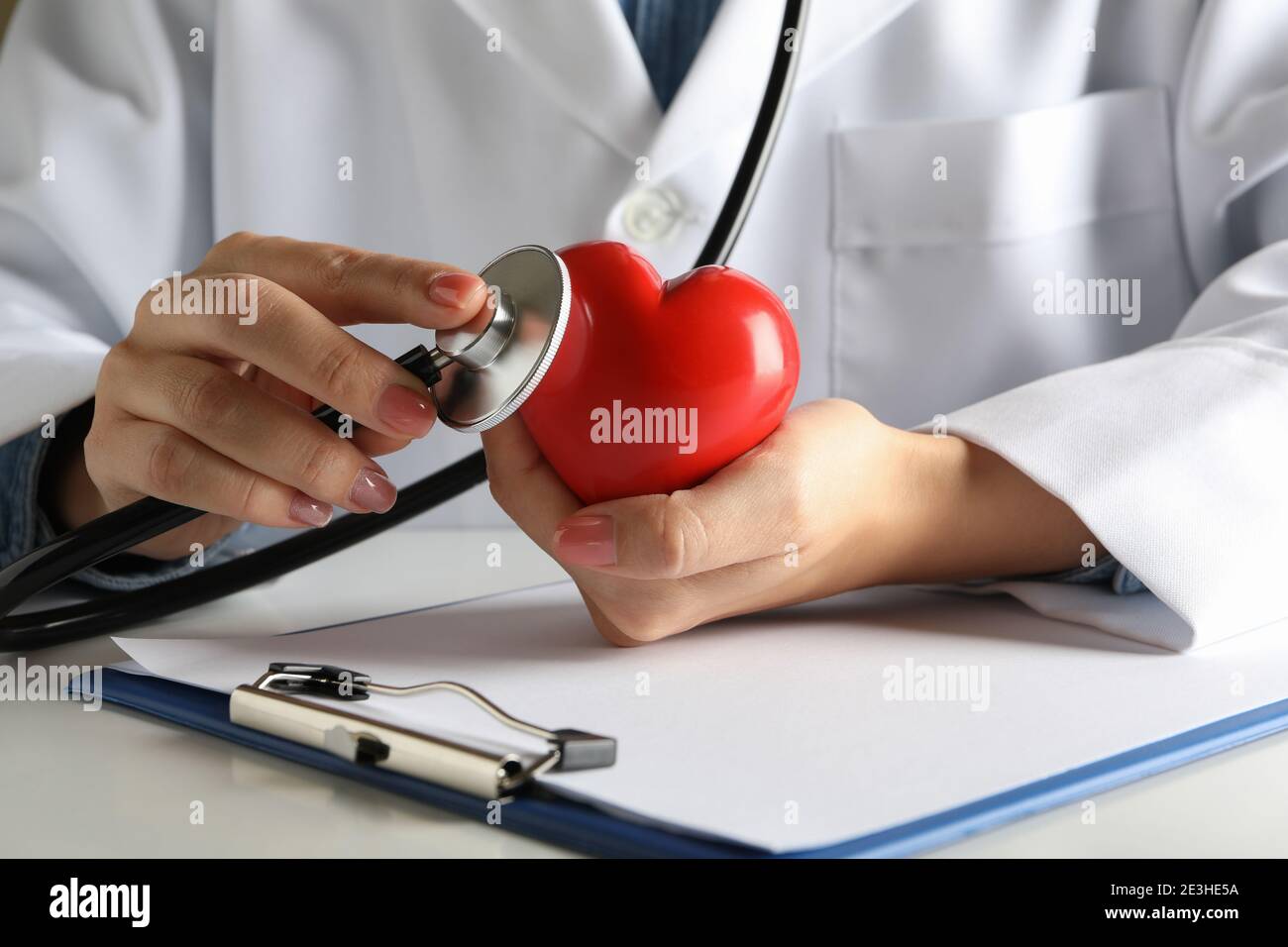 Female doctor with stethoscope checking heart beat Stock Photo - Alamy