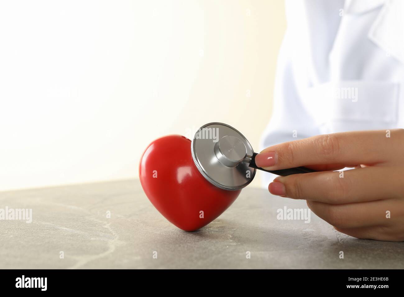 Female doctor with stethoscope checking heart beat Stock Photo - Alamy