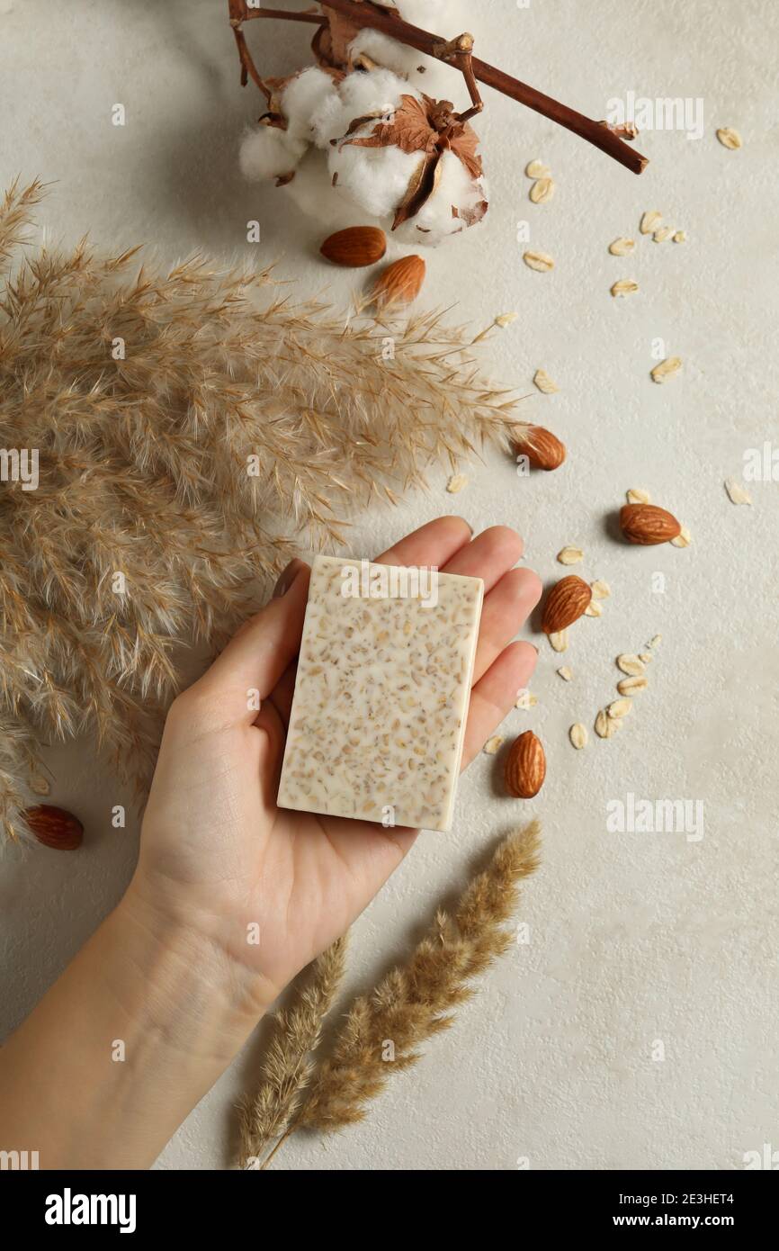 Female hand hold handmade soap on decorated background Stock Photo - Alamy