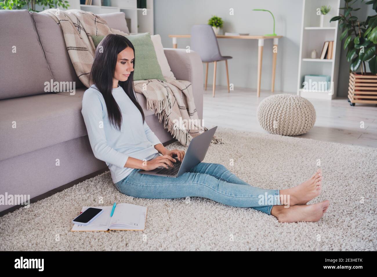 Full size photo of serious woman work from home use laptop typing sit ...