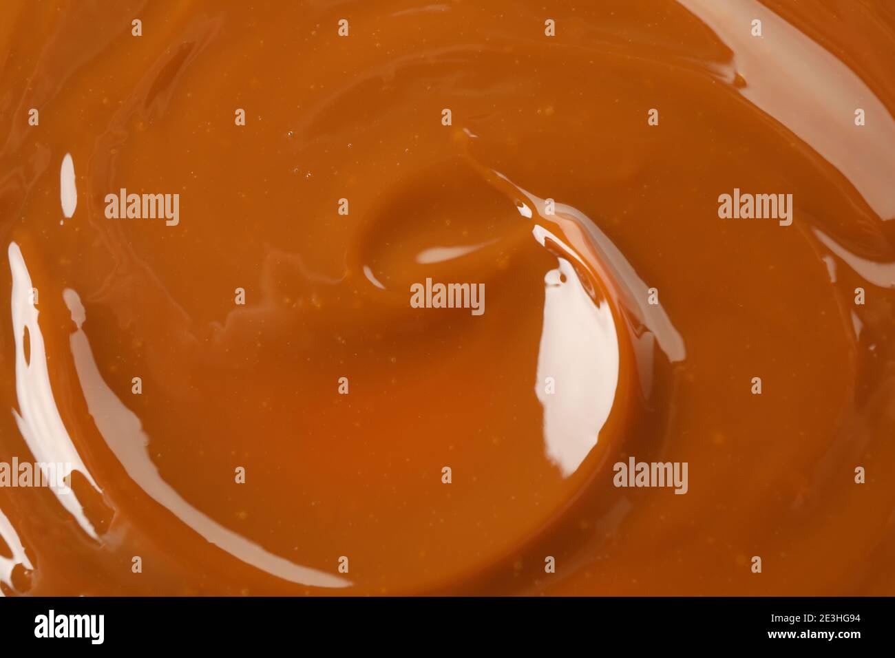 Caramel condensed milk on whole background, close up Stock Photo - Alamy