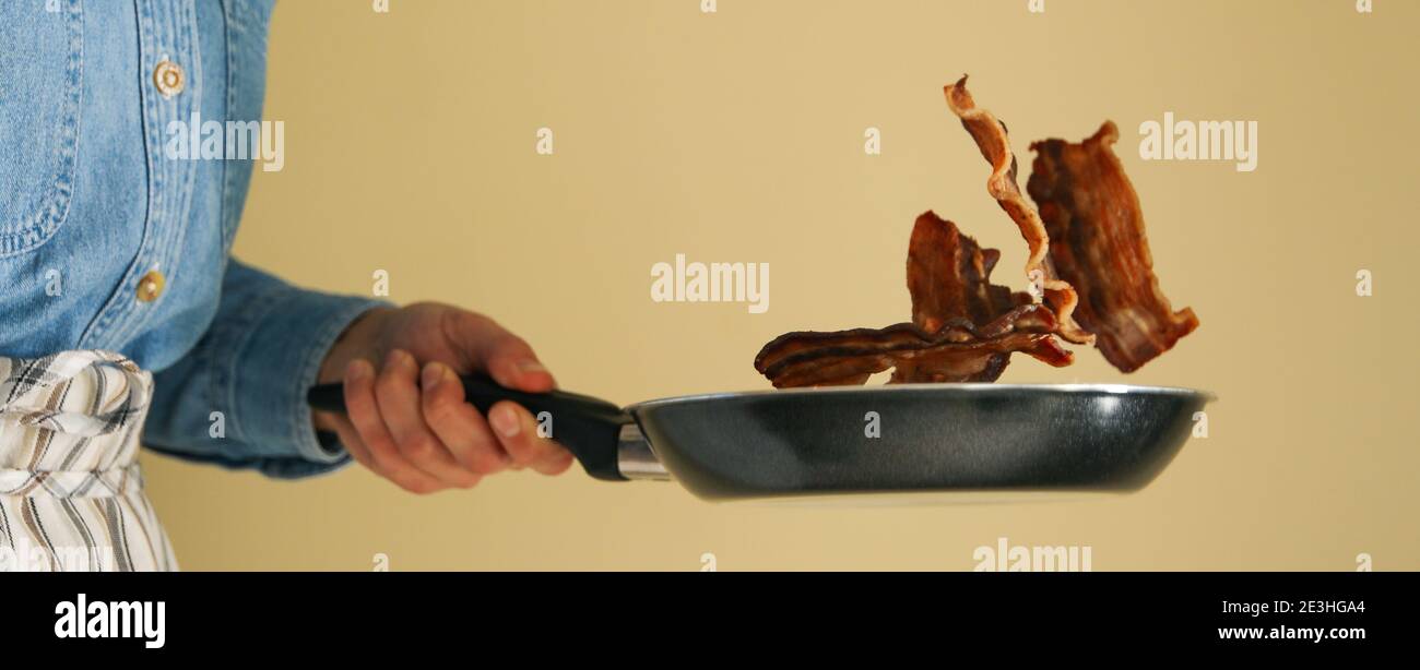 Woman frying bacon hi-res stock photography and images - Alamy