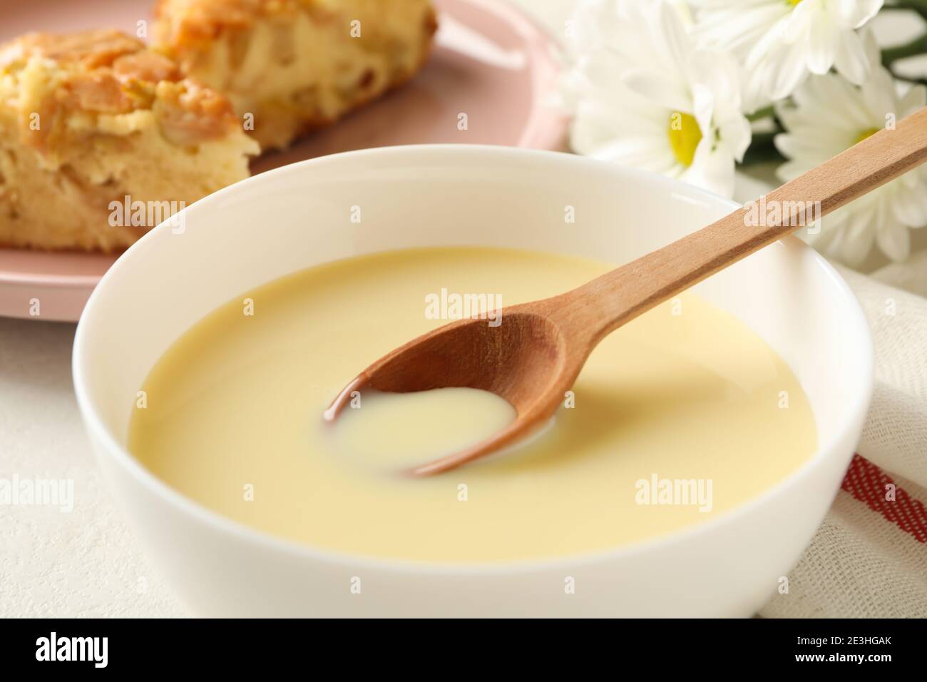 Bowl and spoon with condensed milk, close up Stock Photo - Alamy