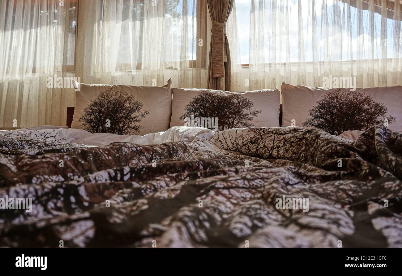 Undone bed in the morning in a cozy bedroom Stock Photo - Alamy