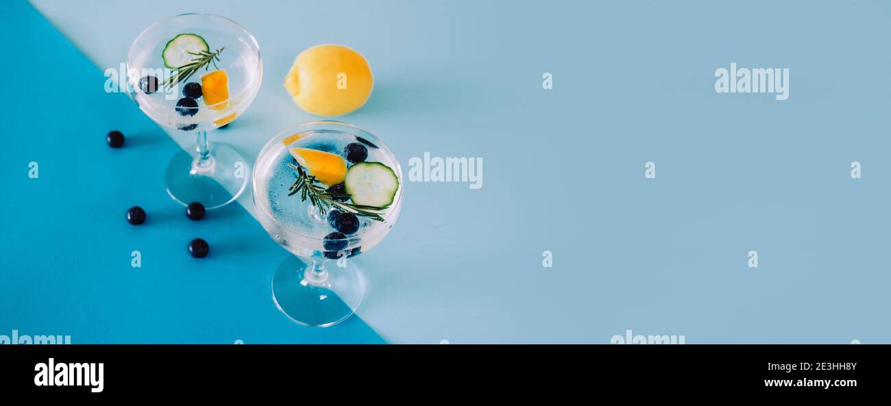 Banner showing two glasses of Gin and tonic cocktails with cucumbers ...