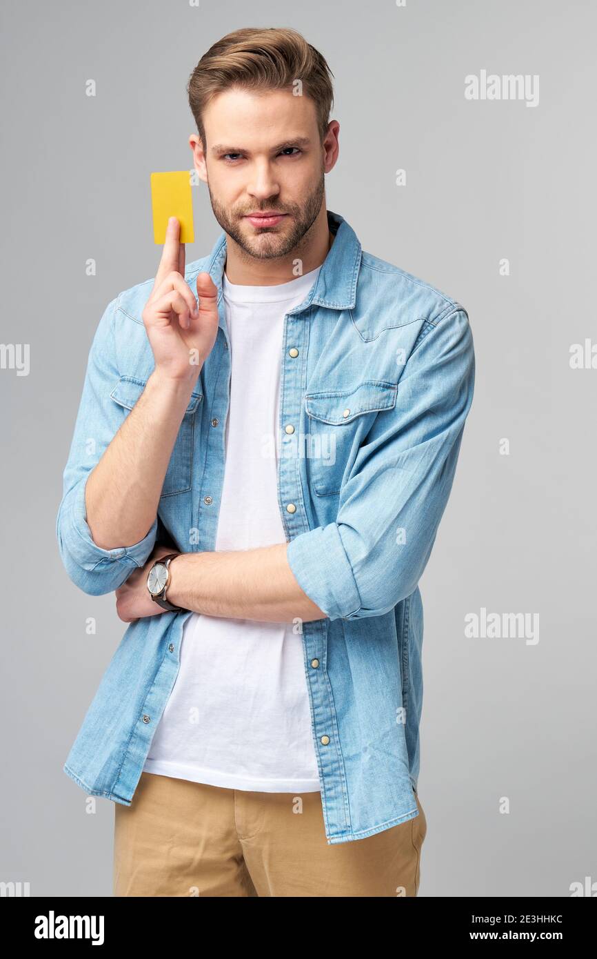 Handsome happy young man showing blank bank cor discount card Stock Photo - Alamy