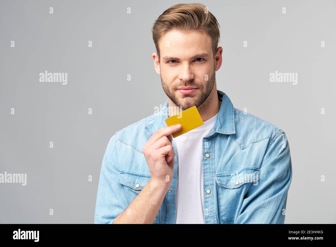 Handsome happy young man showing blank bank cor discount card Stock ...