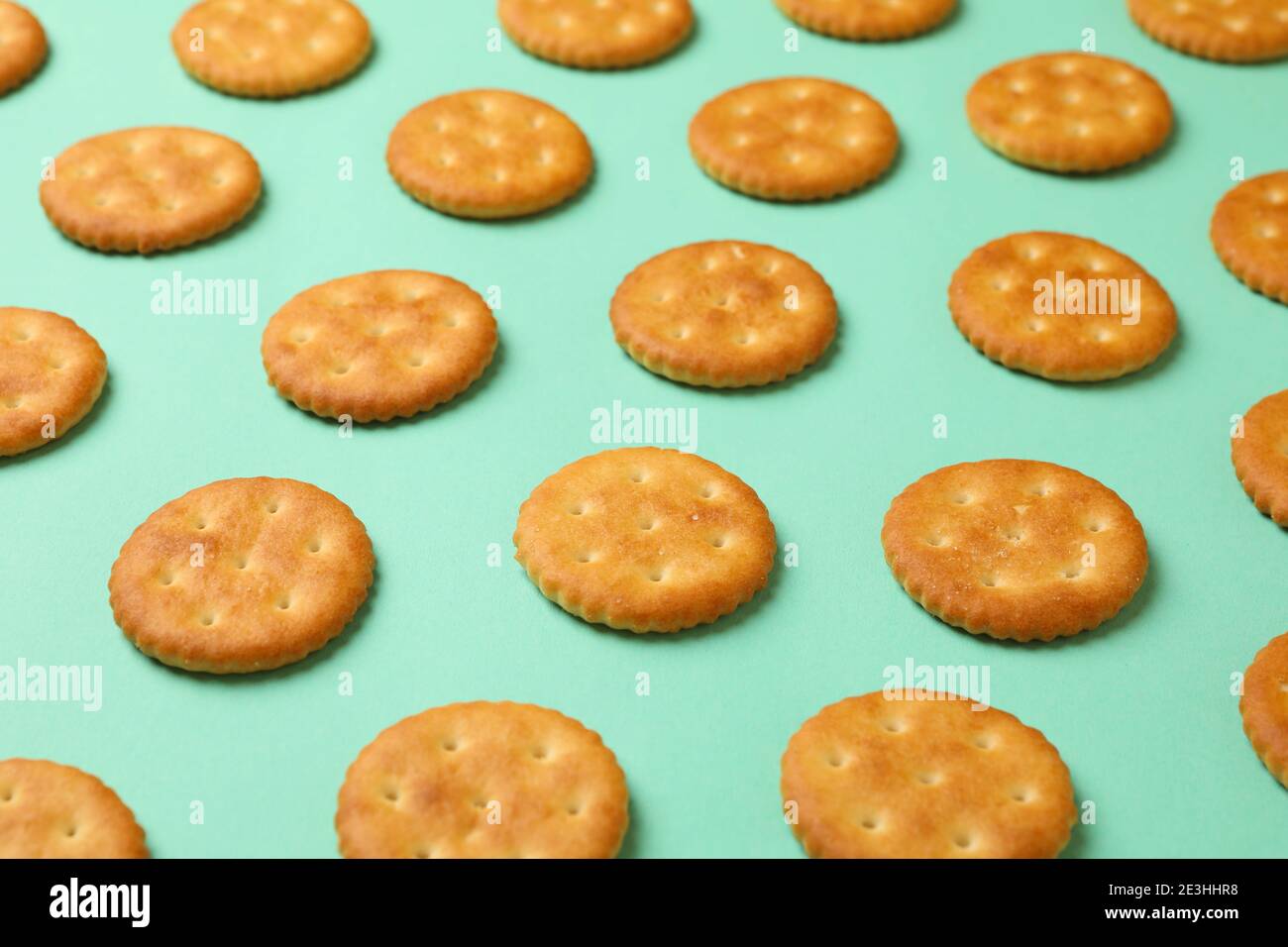 Flat lay with cracker biscuits on mint background Stock Photo - Alamy