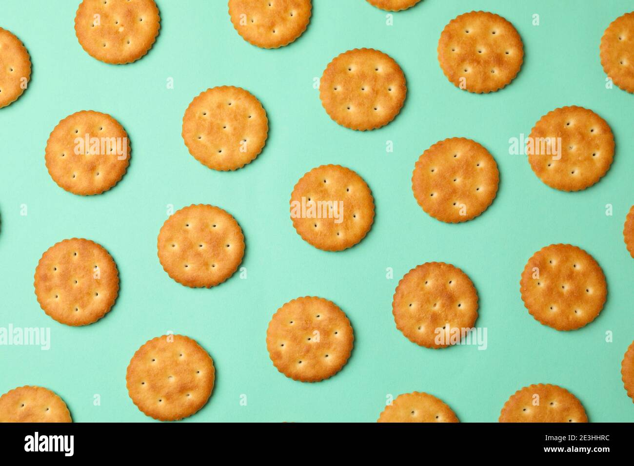 Flat lay with cracker biscuits on mint background Stock Photo - Alamy