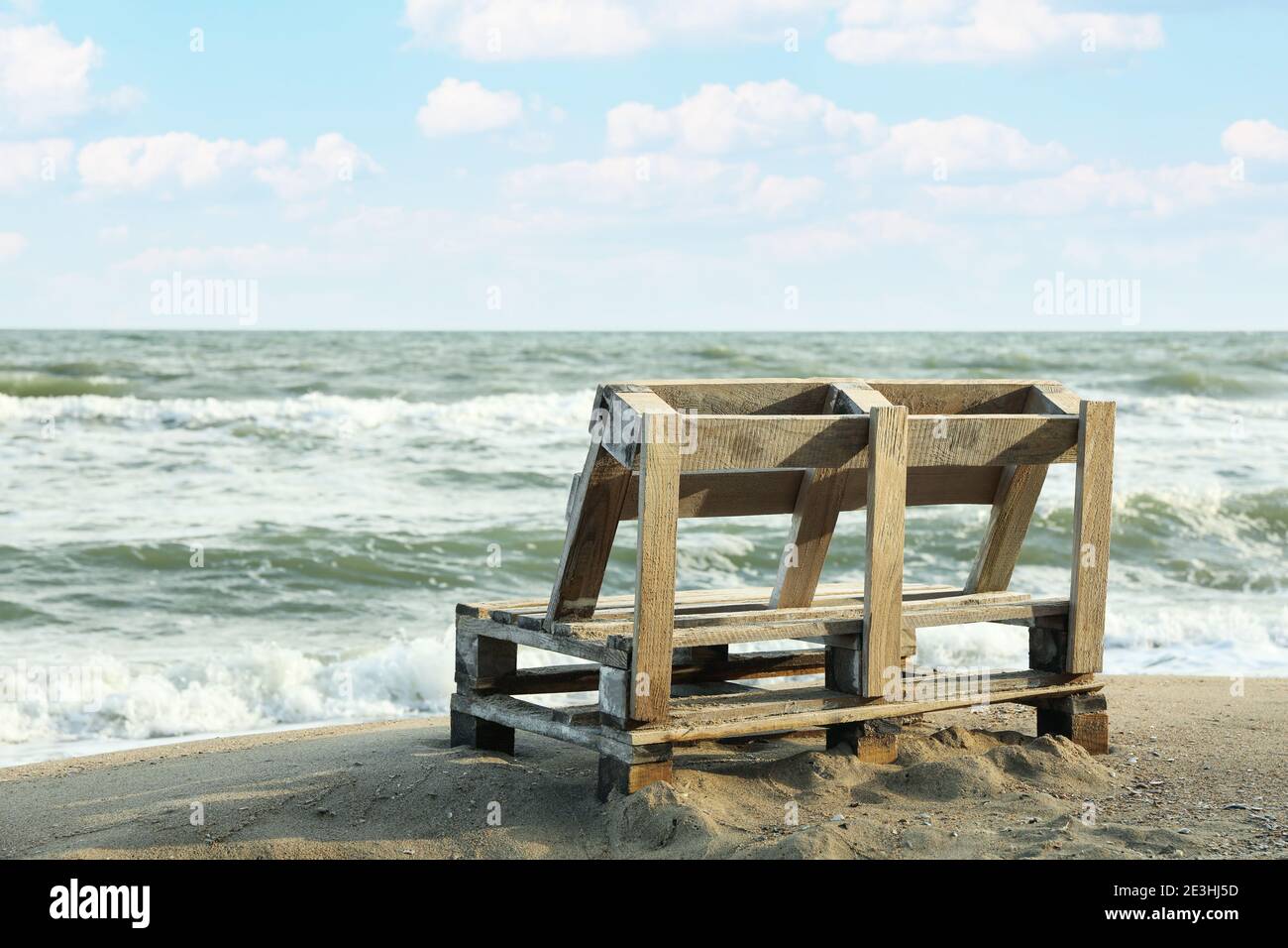 Wooden bench on sandy sea beach, space for text Stock Photo - Alamy