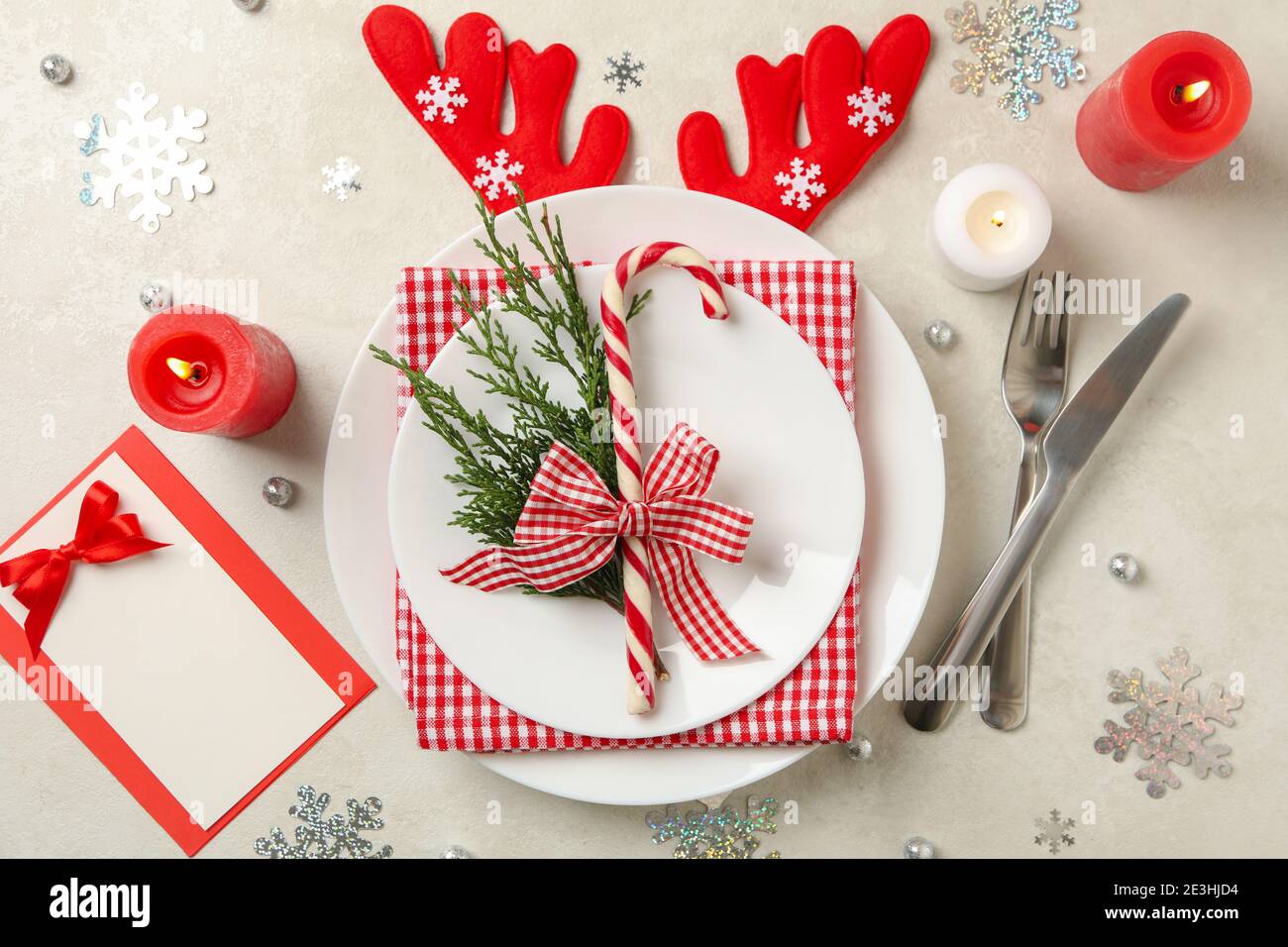 Concept of New year table setting with reindeer horns on white ...