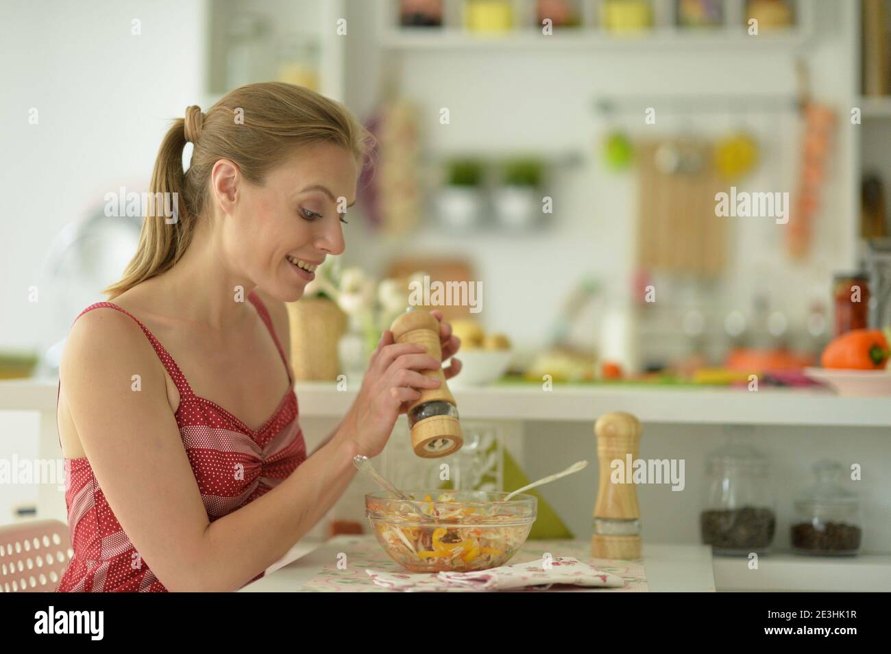 Portrait of beautiful young woman cooking in kitchen Stock Photo - Alamy
