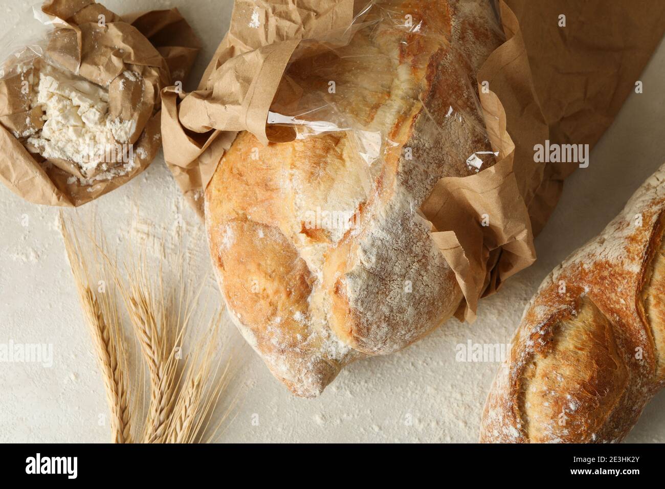 Fresh baked bread and flour on white background Stock Photo - Alamy