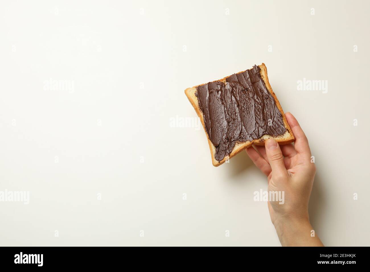 Female hand hold toast with chocolate on white background Stock Photo ...
