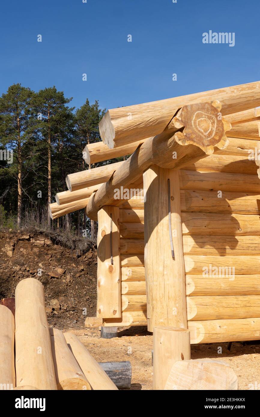 Making ethnic log houses in the open Stock Photo - Alamy