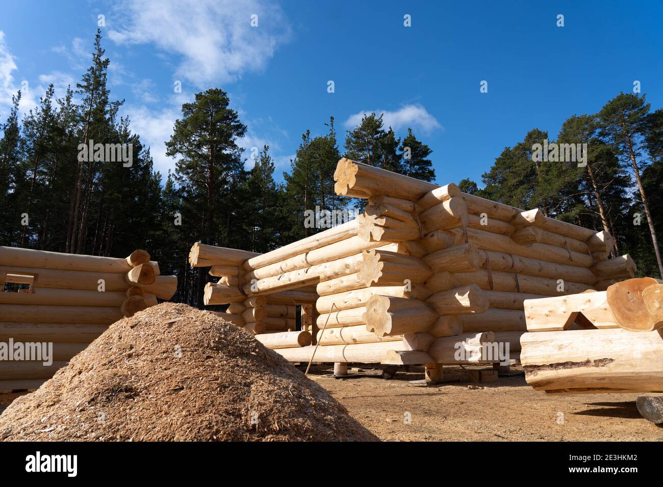 Making ethnic log houses in the open Stock Photo - Alamy