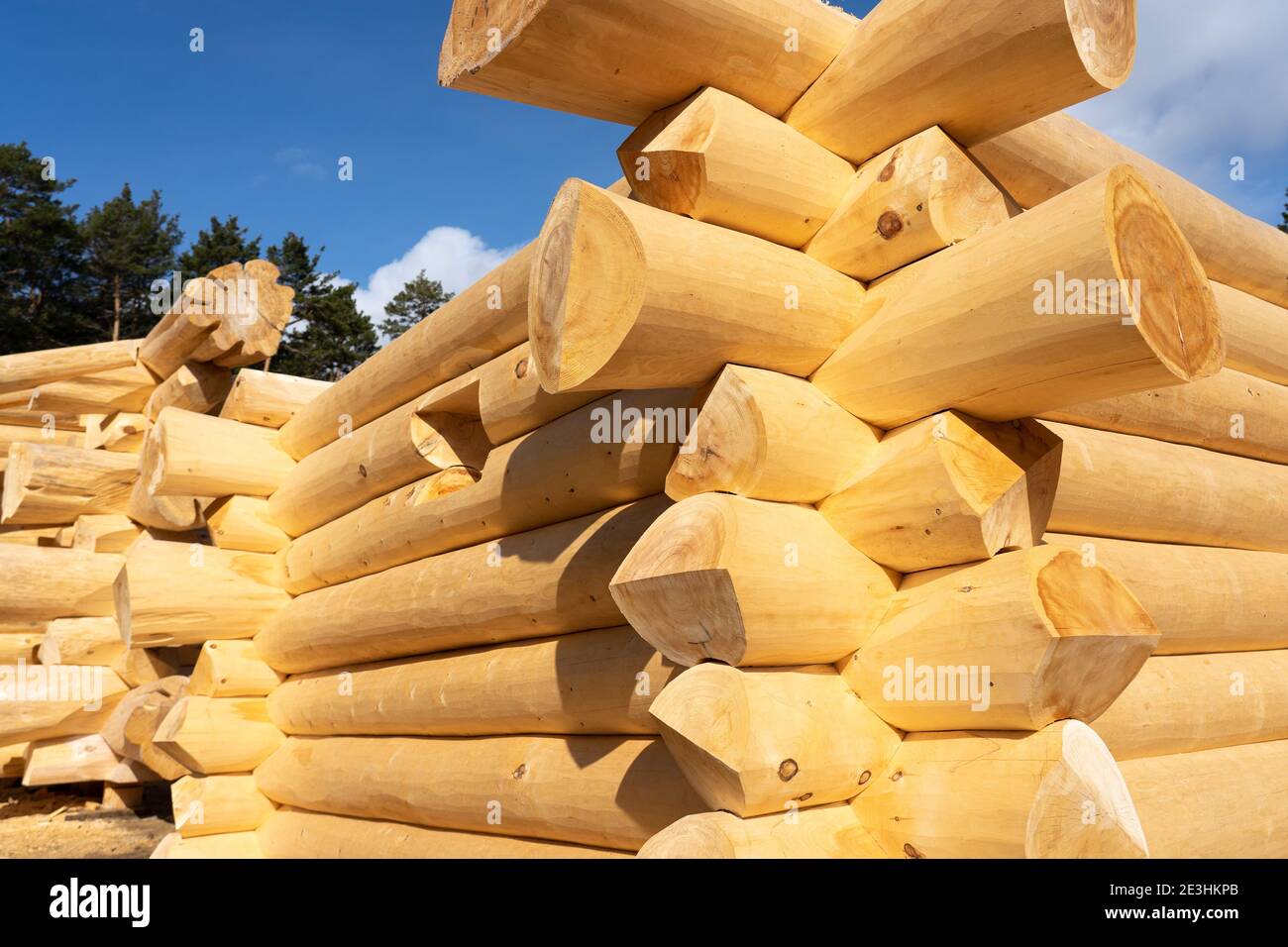 Making ethnic log houses in the open Stock Photo - Alamy