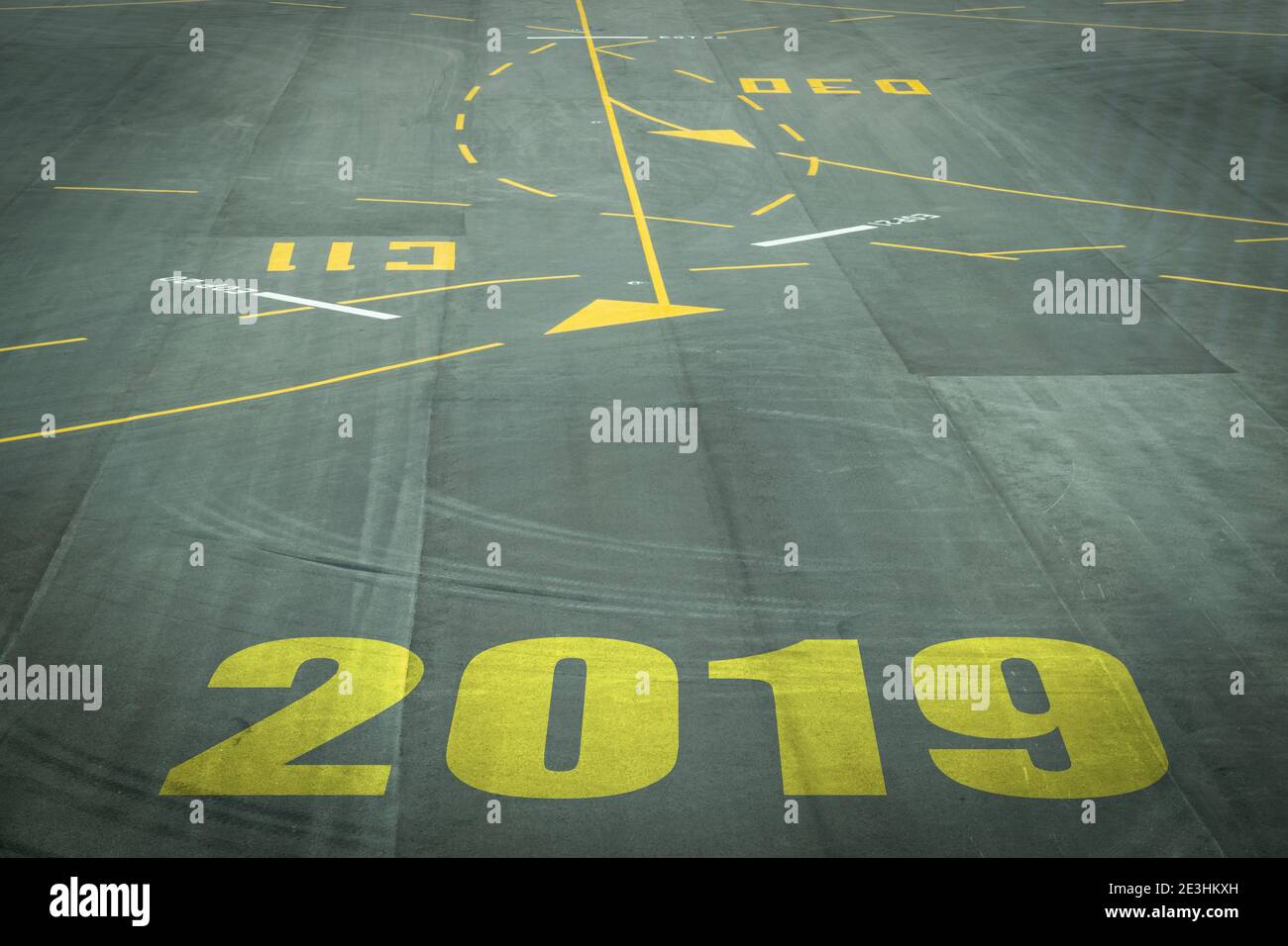 Closeup 2019 figures on the surface of the airport runway texture ...